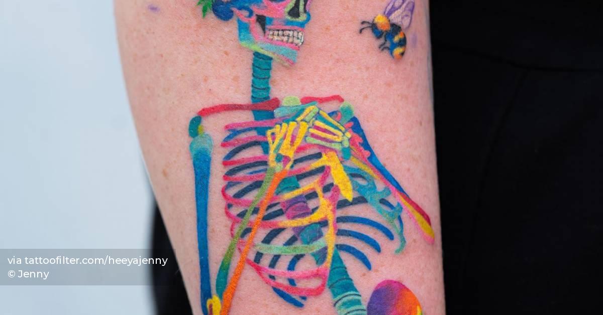 Colorful skeleteon tattoo located on the forearm.