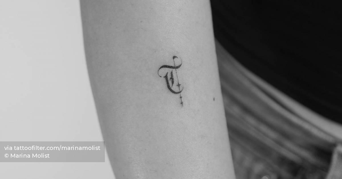 Letter "T" tattoo located on the forearm.