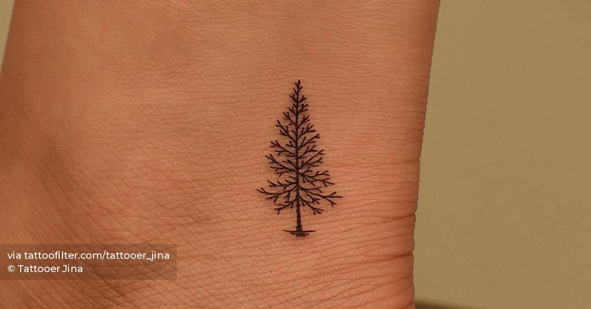 Fine line pine tree tattoo placed on the ankle.