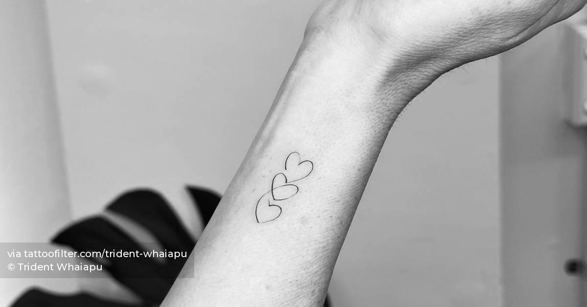 One line hearts tattooed on the wrist, fine line style.