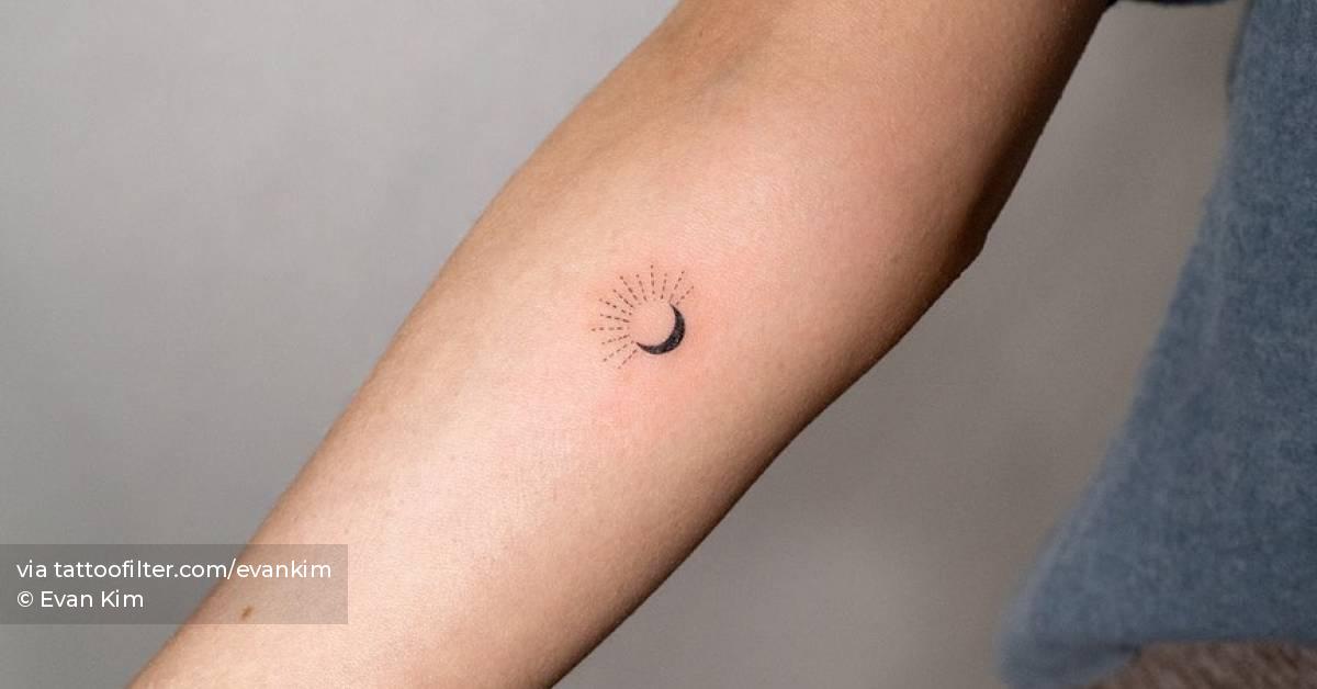 Minimalistic style eclipse tattoo located on the inner
