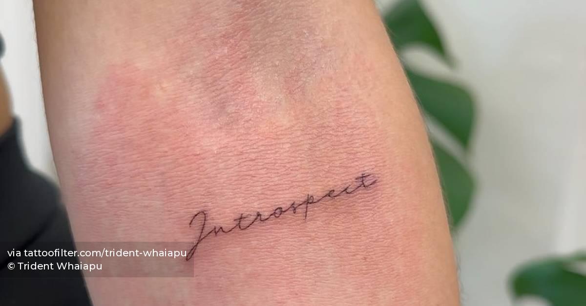 "Introspect" lettering tattoo placed on the inner