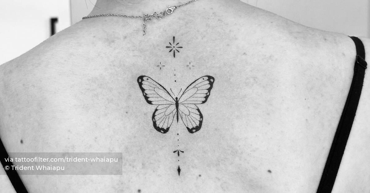 Butterfly tattoo located on the upper back,