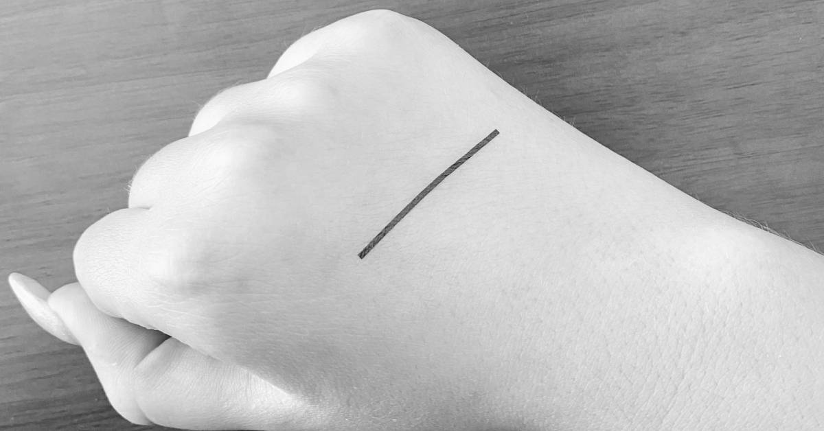 Minimalistic line temporary tattoo located on the hand.