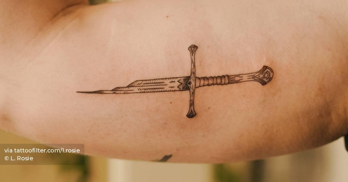 Broken sword tattoo located on the inner arm,