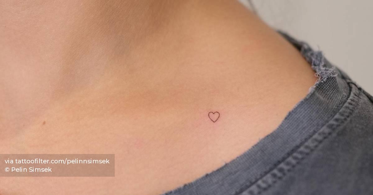 Micro tattoo of a minimalistic heart located on the