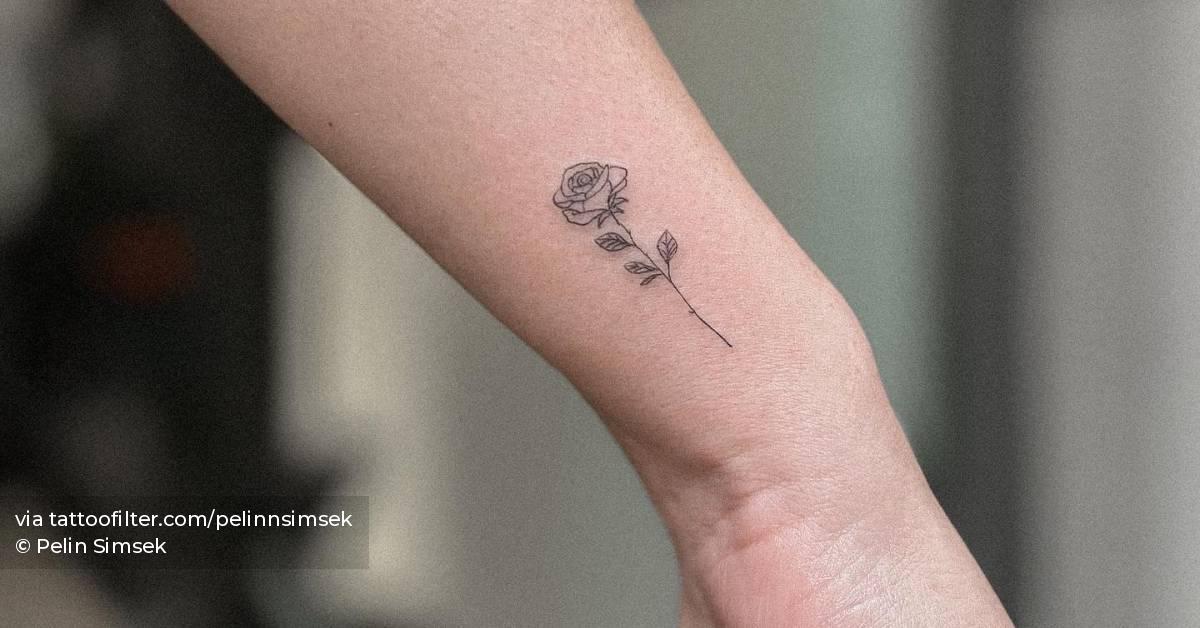 Fine line style rose tattoo placed on the wrist.