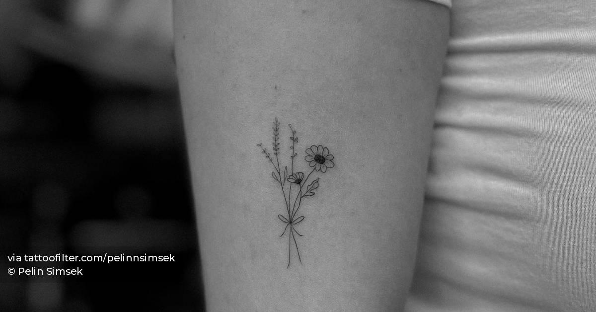 Fine line style flower bouquet tattoo located on the