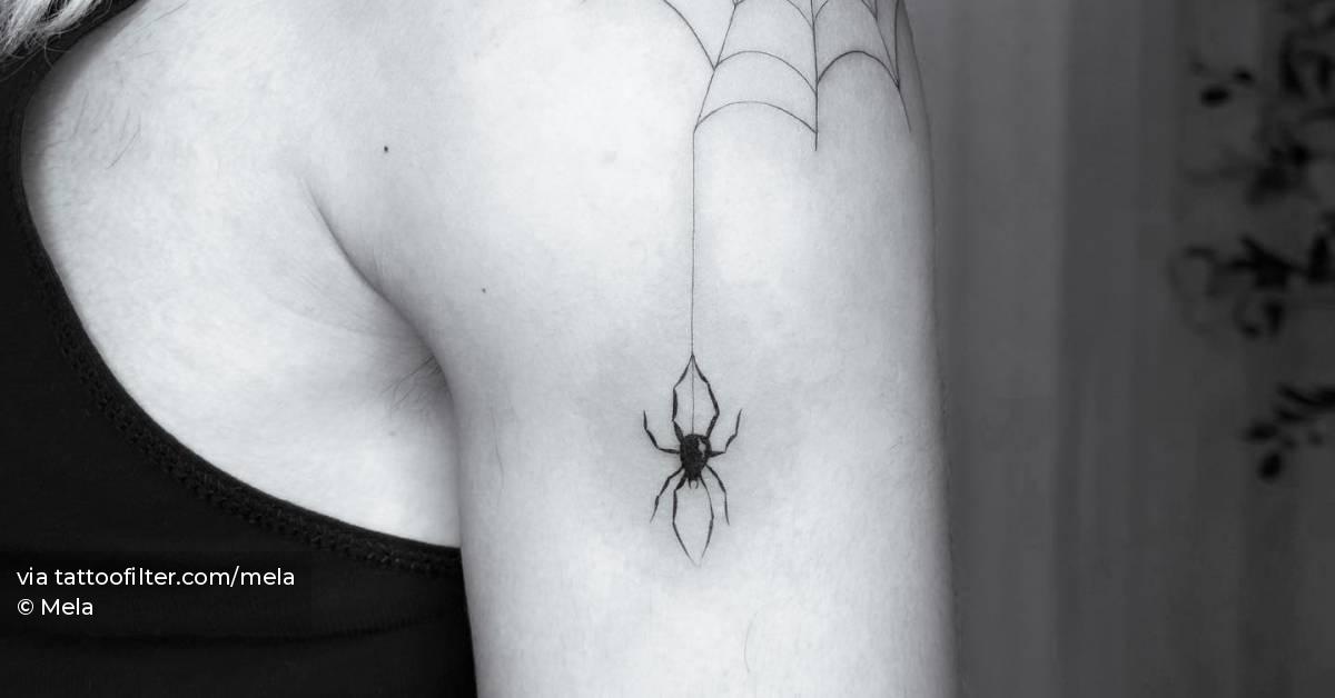 Illustrative style spider tattoo located on the