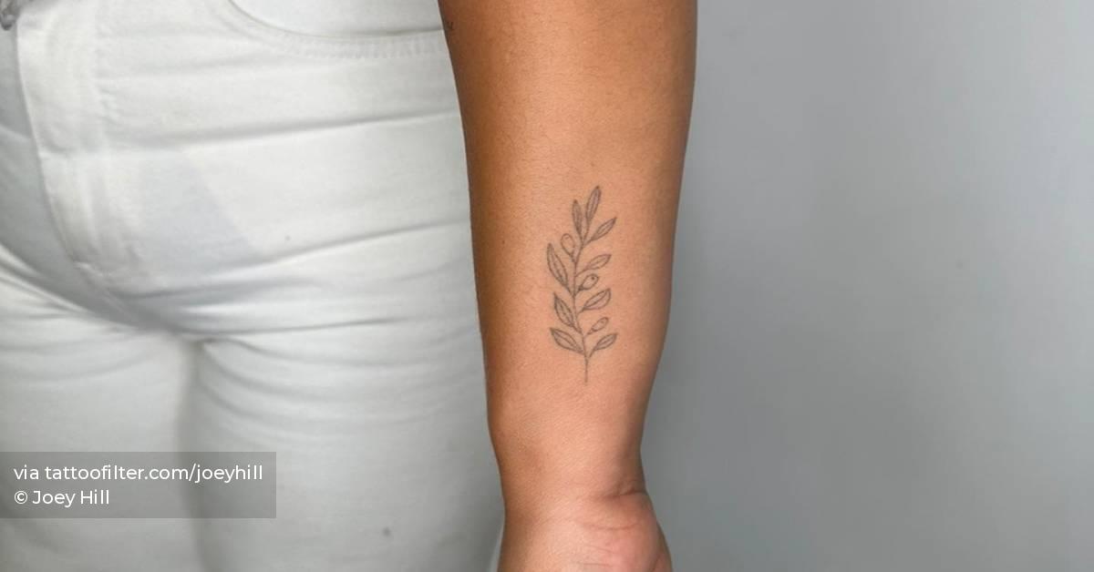 Healed fine line floral tattoo located on the wrist.
