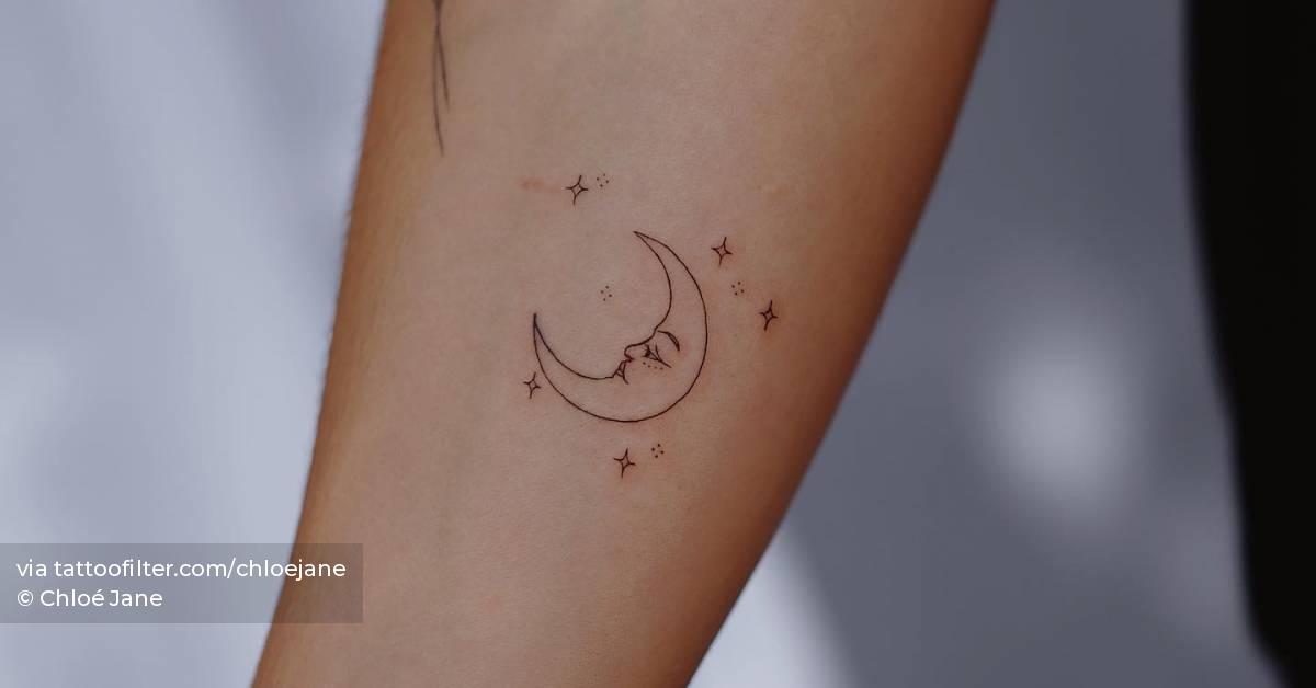 Fine line style moon face tattoo located on the inner