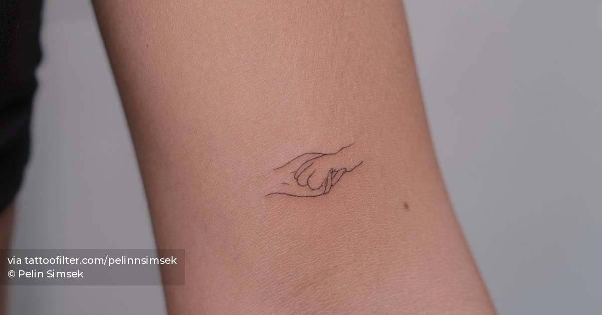 Fine line style hand and paw tattoo placed on the