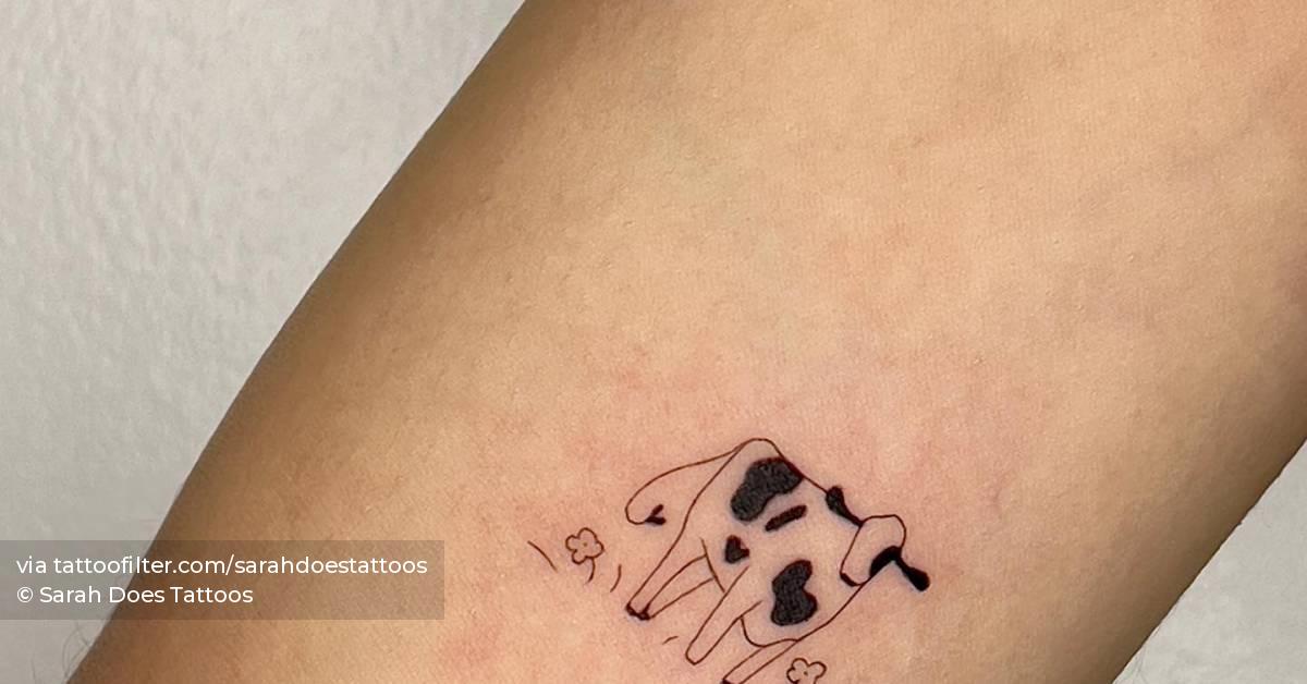 Minimalistic cow tattoo located on the inner arm.
