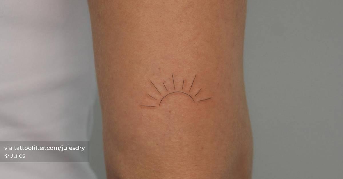 Minimalistic style sunset tattoo done on the tricep.