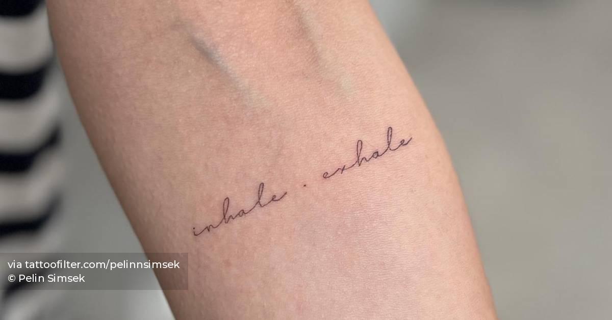 Words "inhale, exhale" tattooed on the inner forearm.