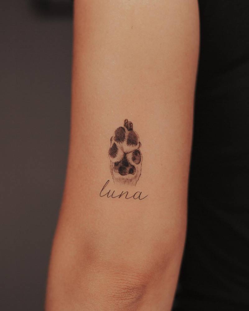 Micro realistic Dog Paw And Name Luna Tattooed On The Micro realistic Dog Paw And Name Luna Tattooed On The