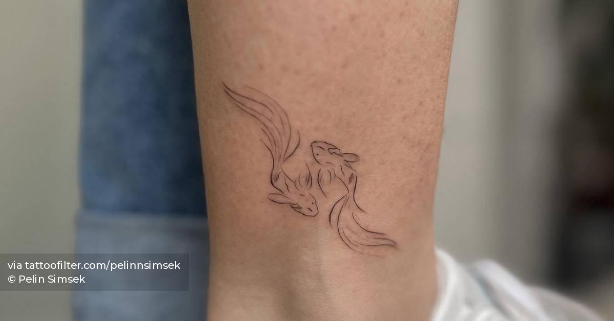 Fine line style two opposite fish tattoo done on the