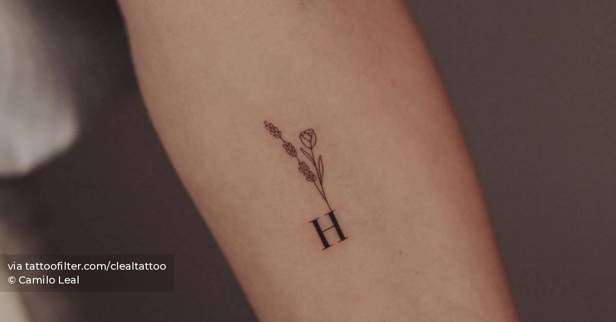Flowers and letter "H" tattoo done on the inner