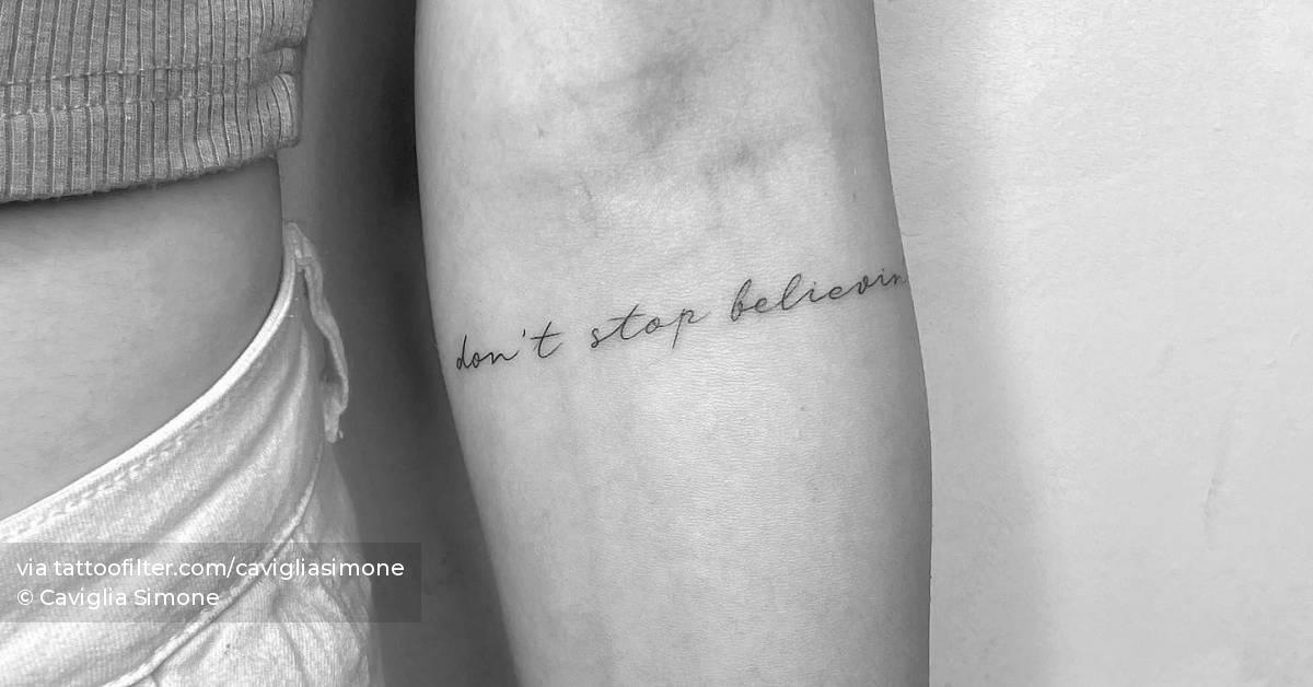 "Don't stop believing" lettering tattoo located on the