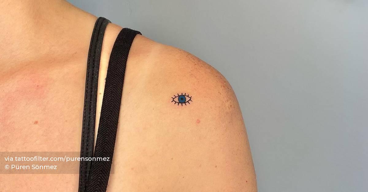 Minimalistic style evil eye tattoo done on the