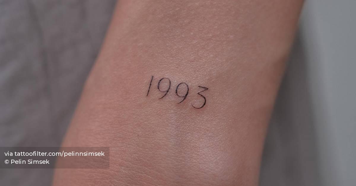 "1993" lettering tattoo located on the wrist.