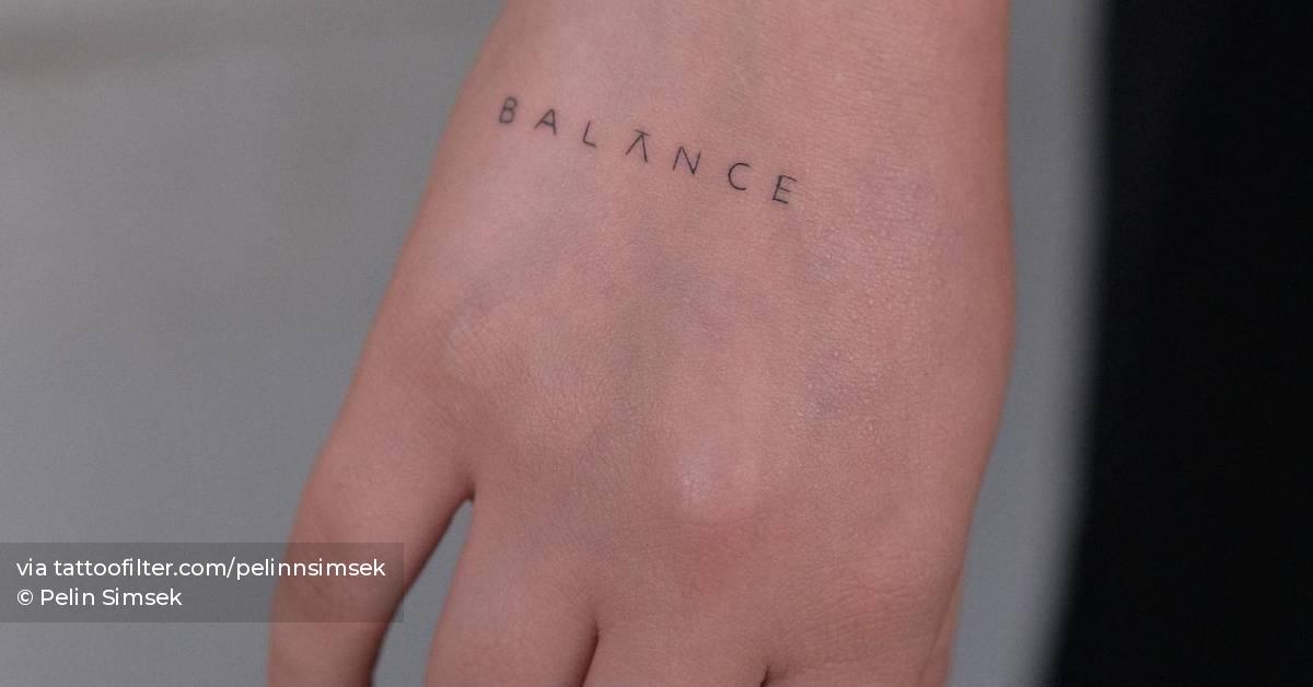 Tattoo of the word "balance" located on the hand.
