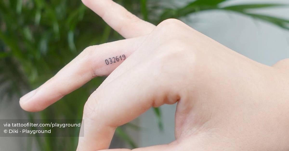 Number tattoo located on the finger.