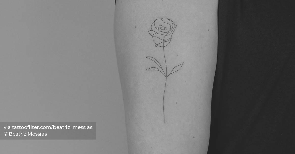 Continuous line rose tattoo located on the upper arm.