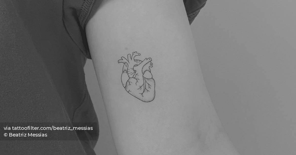 Anatomical heart tattoo placed on the inner arm, fine