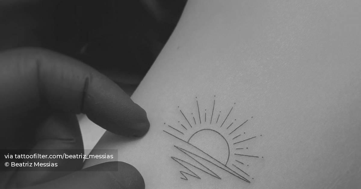 Fine line style sea sunset tattoo done on the upper