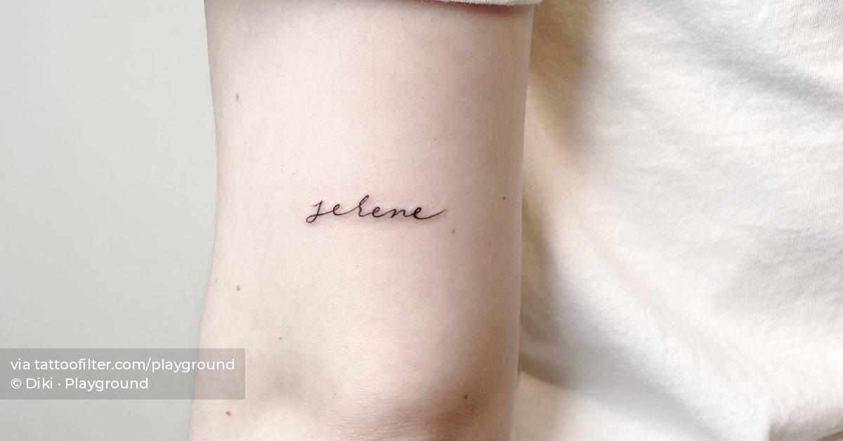 Tattoo of the word "serene" handwritten on the tricep.