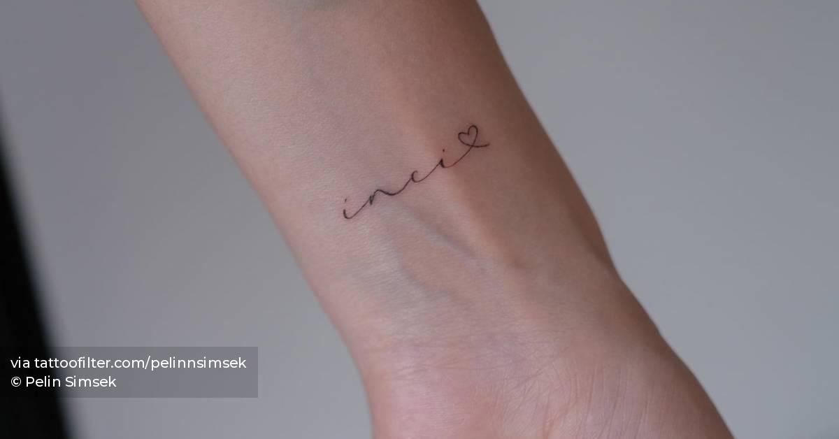 Tattoo of the name "Inei" located on the wrist.
