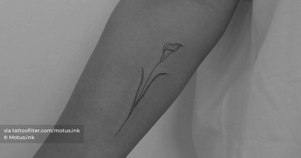 Fine line style calla lily flower tattoo located on the