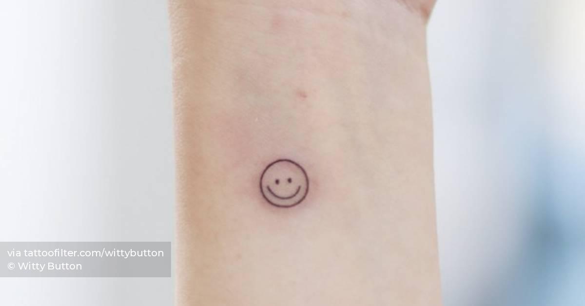 Tiny smiley face tattoo done on the wrist, minimalistic