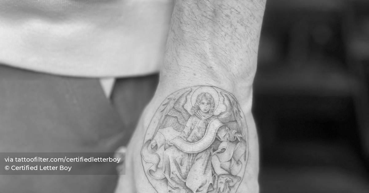 Angel tattoo located on Oliver Burke's hand.