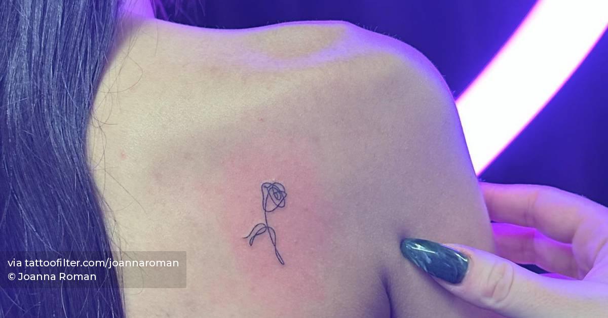 One line rose tattoo located on the shoulder blade.