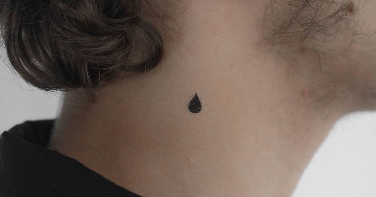Minimalistic style tear drop temporary tattoo located