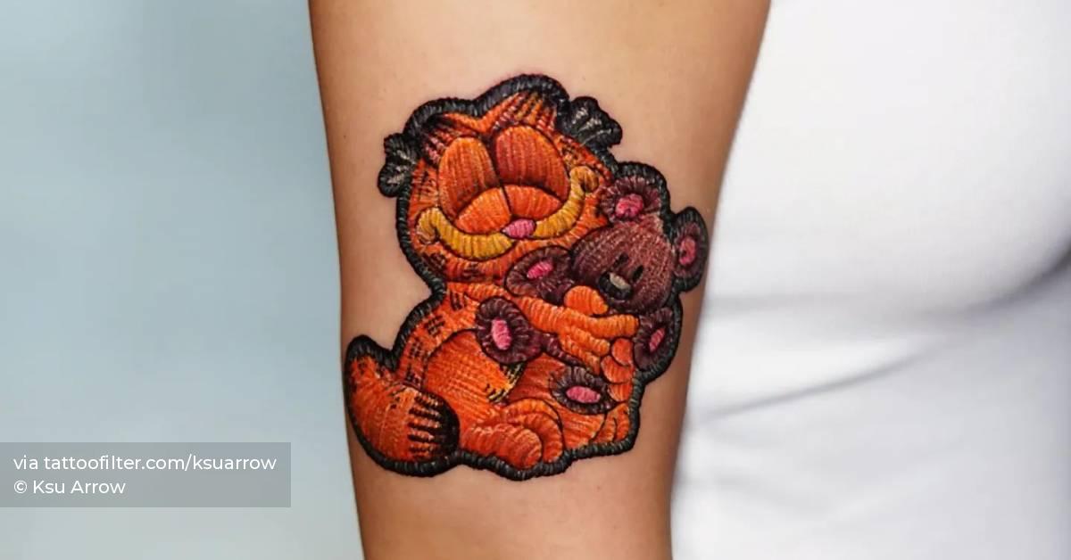 Garfield patch tattoo placed on the upper arm,