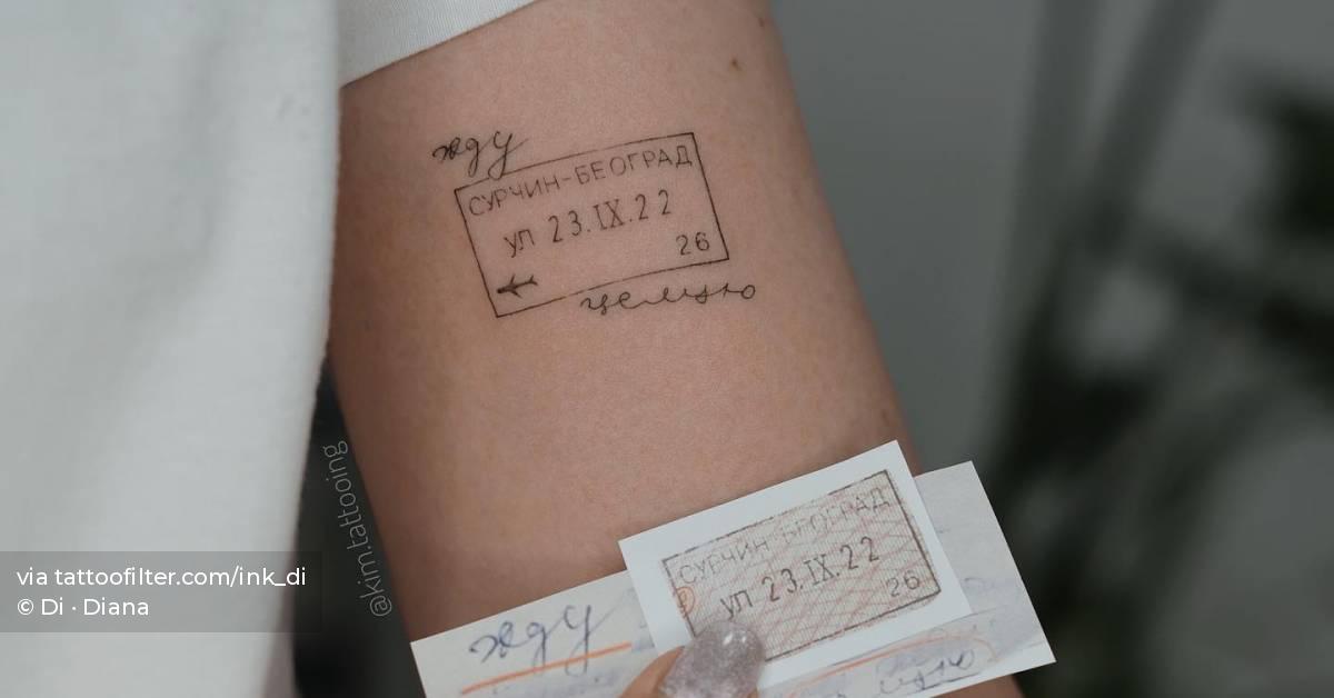 Travel stamp tattoo placed on the bicep, illustrative
