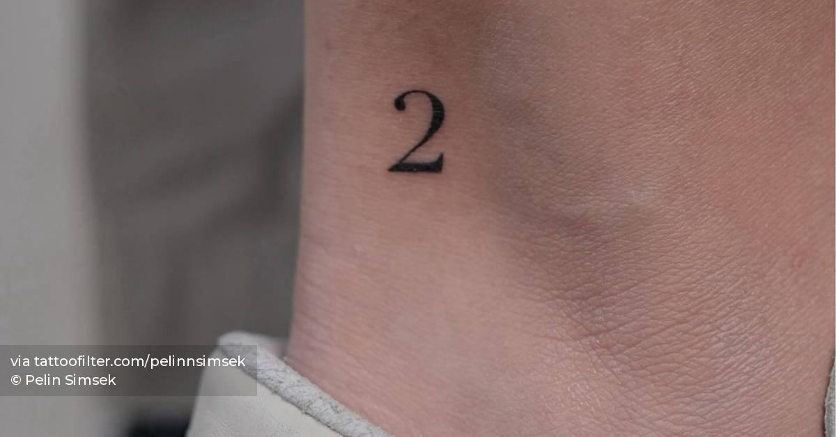 Little tattoo of the number "2" placed on the ankle.