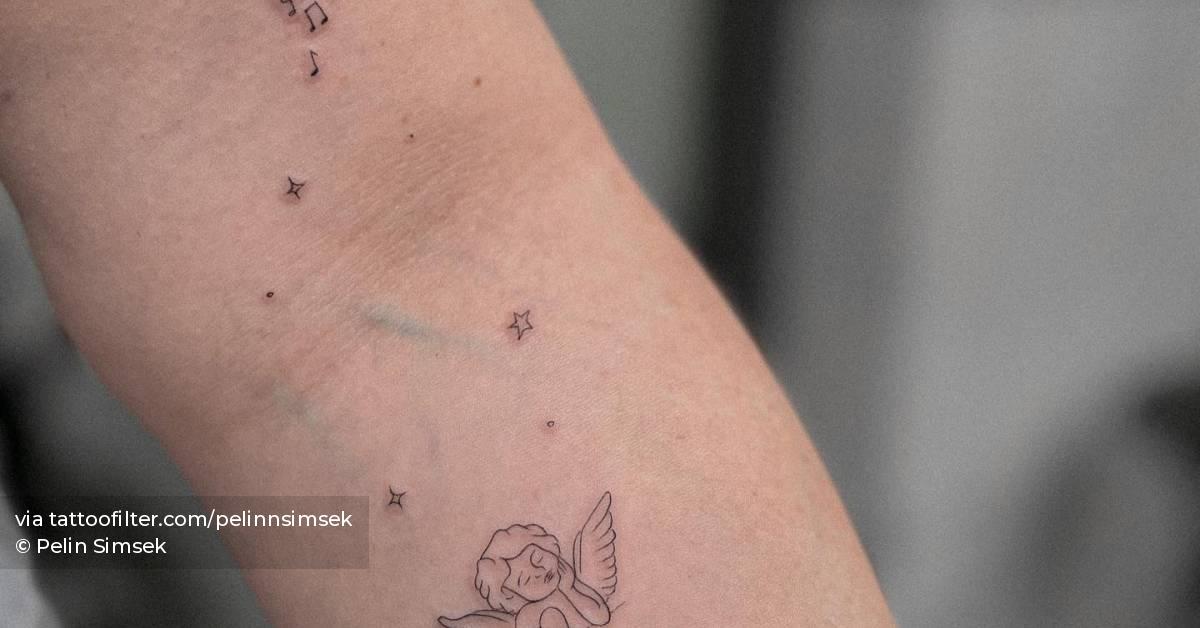 Fine line style cherubs tattoo located on the arm.