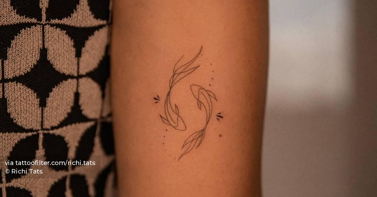 Fine line style two opposite fish tattoo located on the