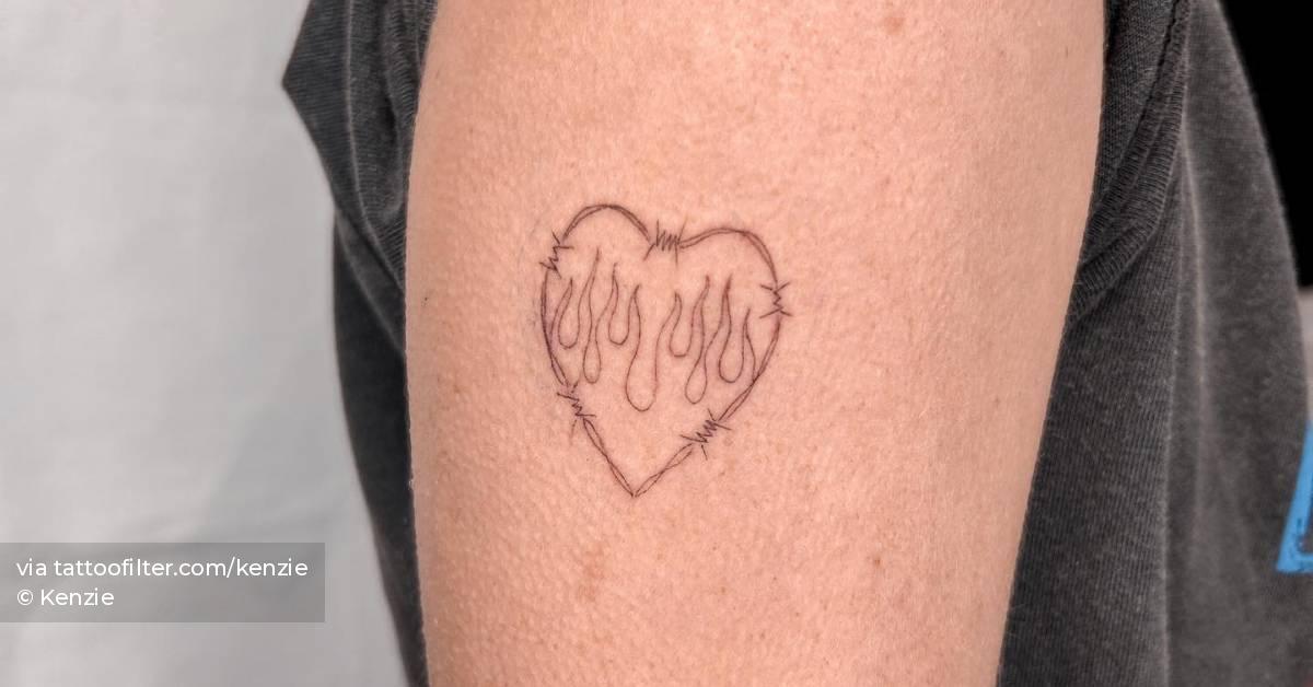 Flaming barbed wire heart tattoo located on the upper