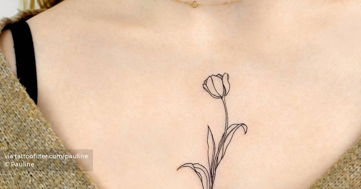 Fine line style tulip tattoo located on the chest.