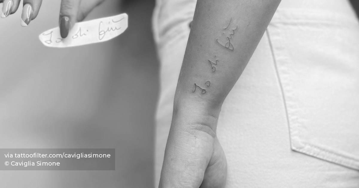 Handwritten lettering tattoo located on the wrist.