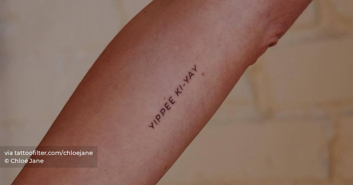 "Yippee Ki Yay" lettering tattoo located on the inner