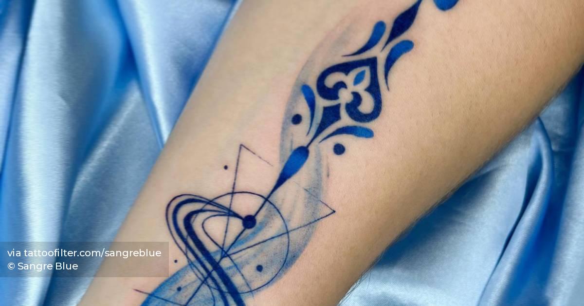 Blue Trident tattoo located on the inner forearm.