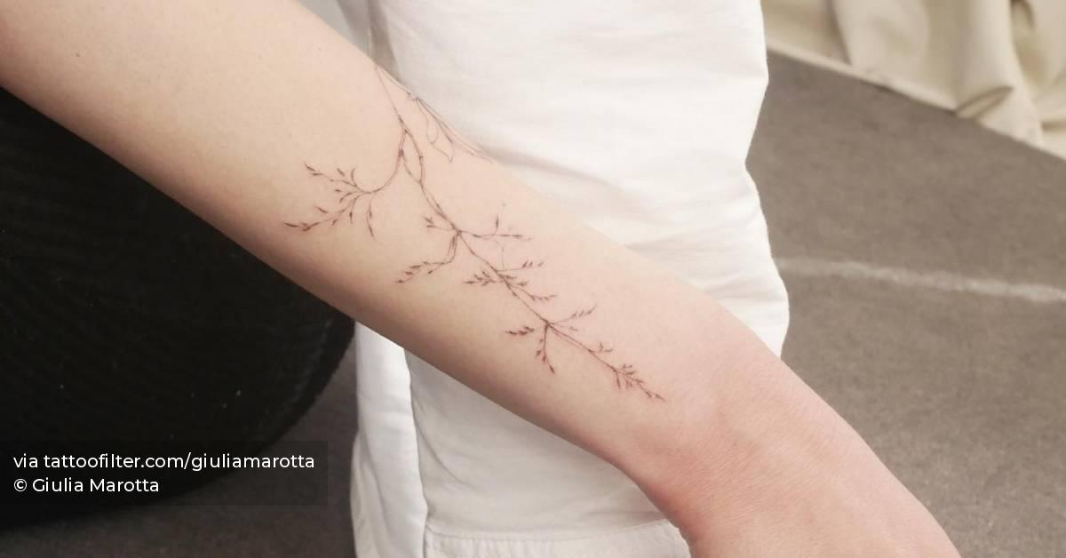 Grass tattoo located on the forearm, illustrative