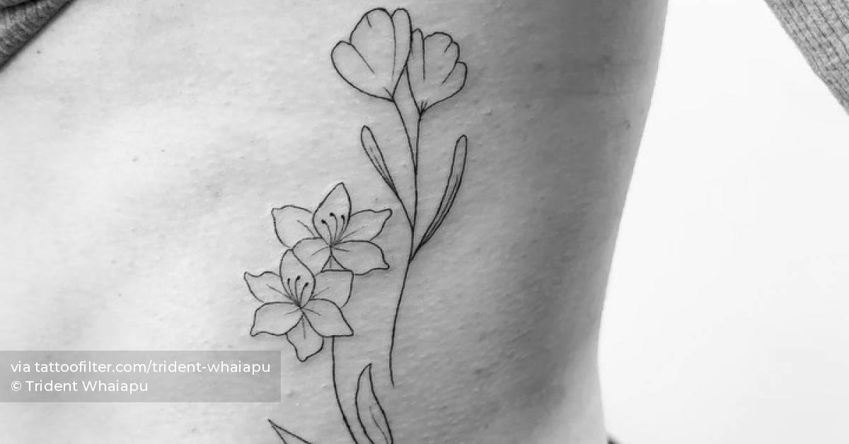 Illustrative style flowers tattoo located on the rib.