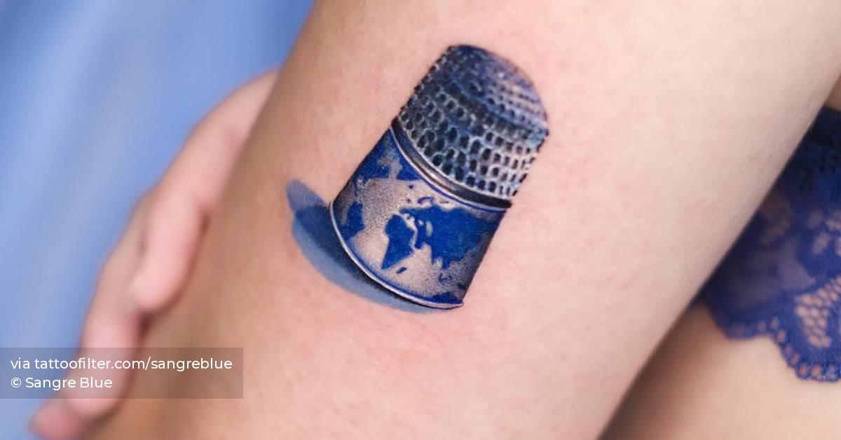 Porcelain thimble tattoo located on the tricep.
